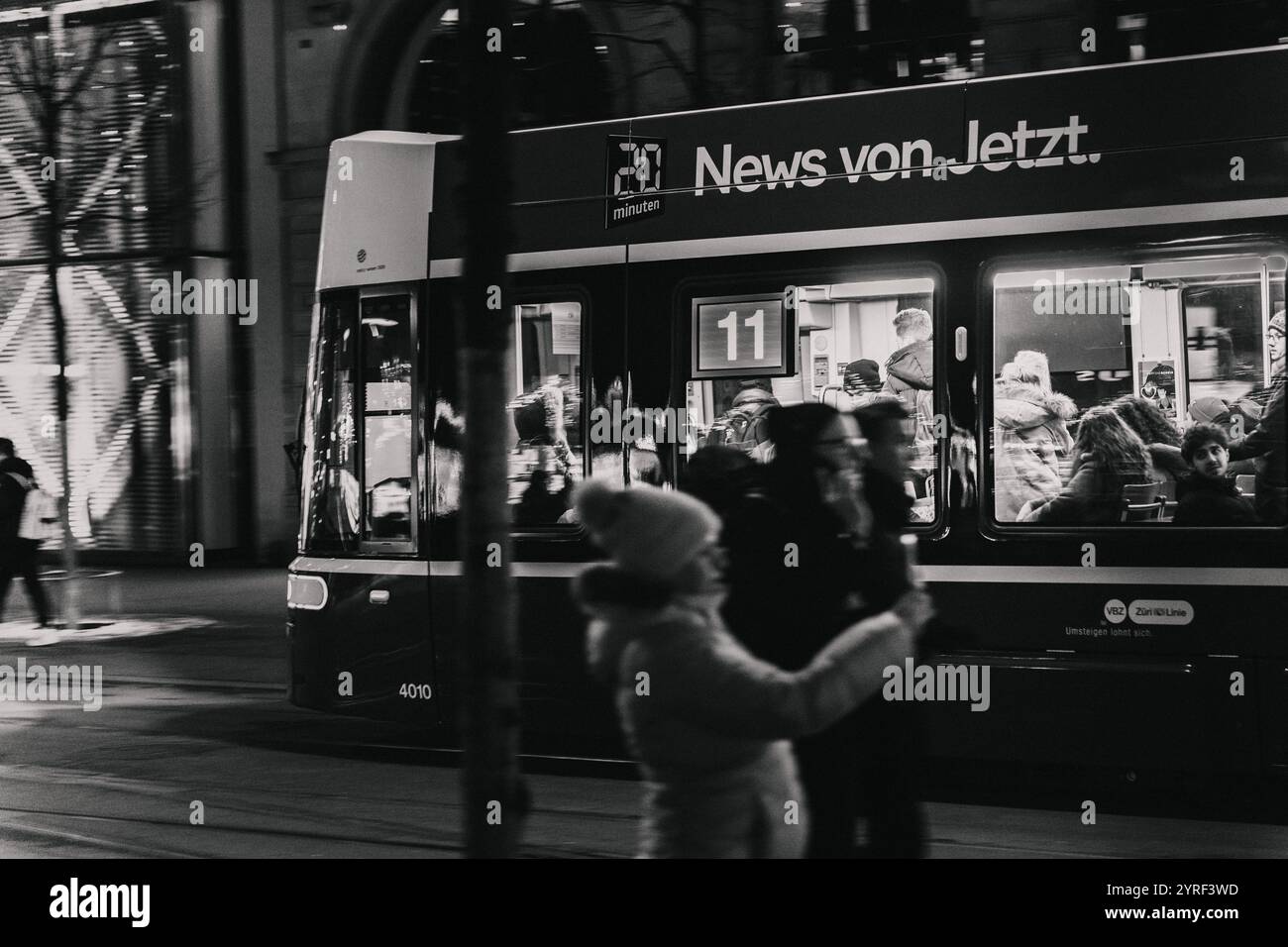 A lively Swiss street scene with people walking, surrounded by charming ...