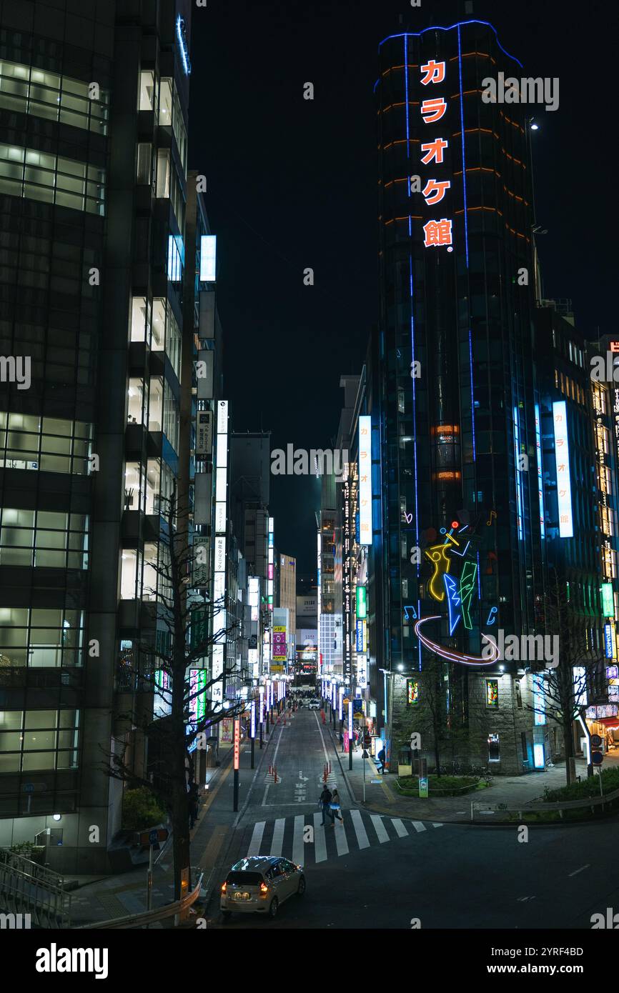 Shinjuku at night dazzles with vibrant neon lights, bustling streets ...
