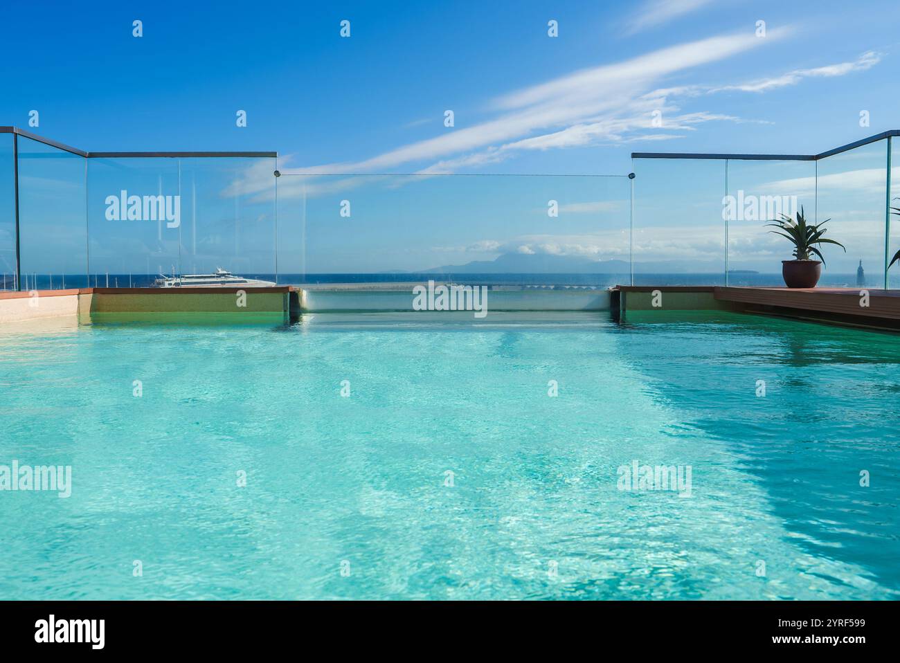 Luxurious Rooftop Infinity Pool Overlooking Ocean with Yacht Stock ...