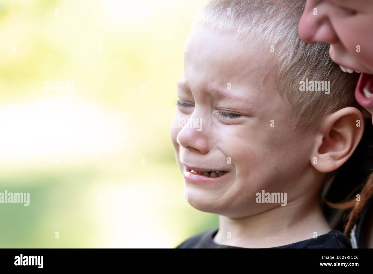 Portrait of a crying boy with a screaming mother Stock Photo - Alamy