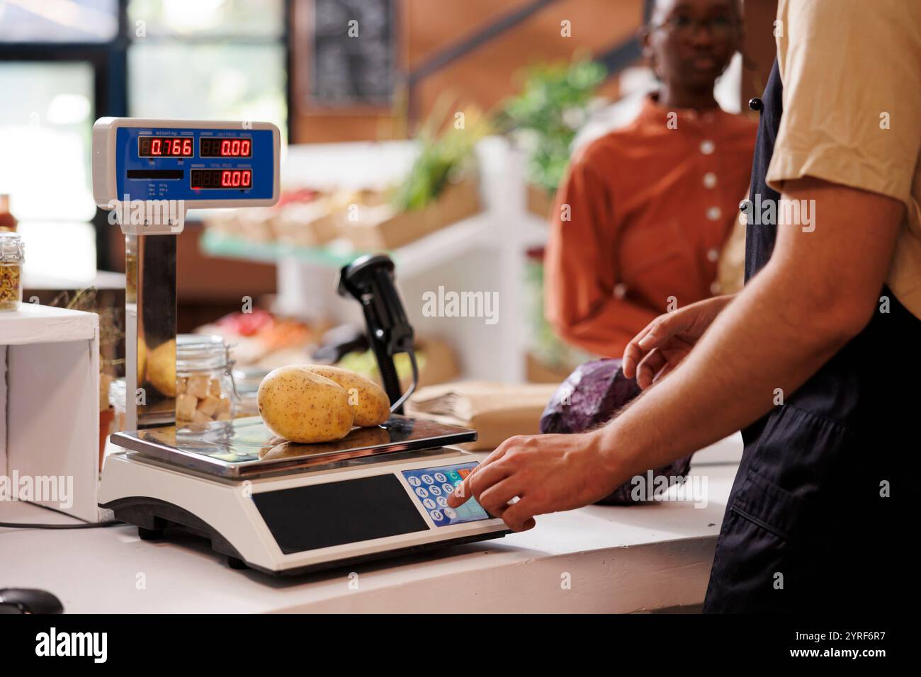 Male shopkeeper at the checkout counter of nearby convenience store ...