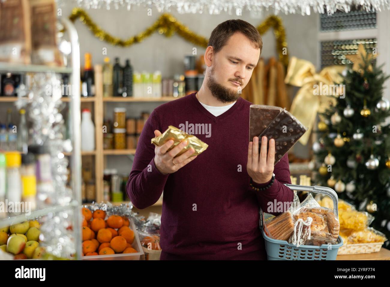 Man choosing chocolate in the supermarket Stock Photo - Alamy