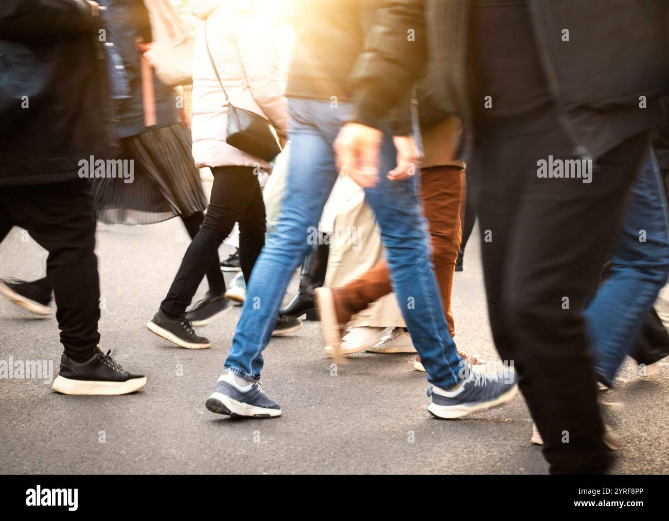 Pedestrians walking in abstract urban scene depicting feet of crowd of ...