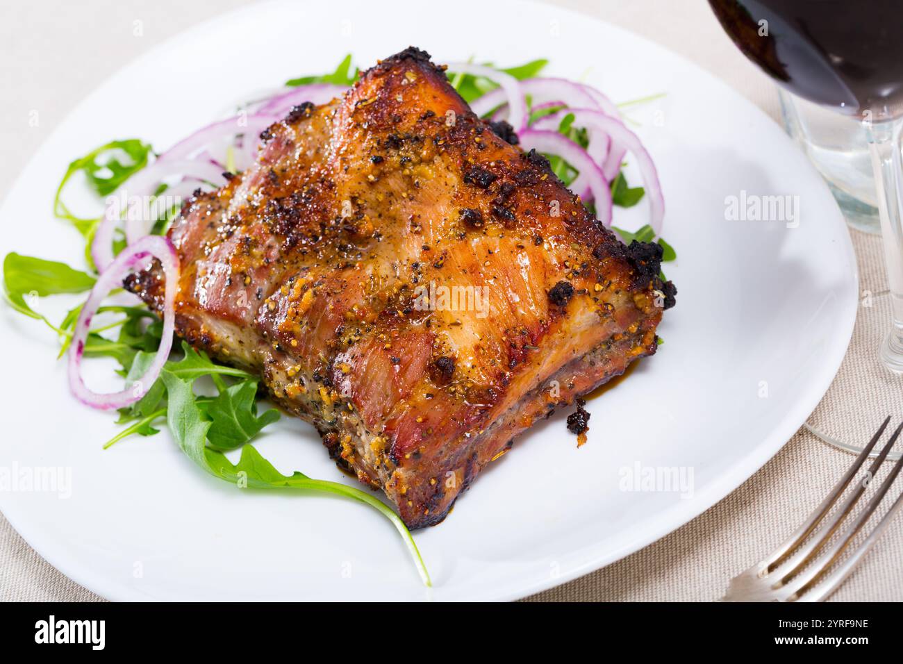 Roasted pork rack of ribs with greens Stock Photo - Alamy