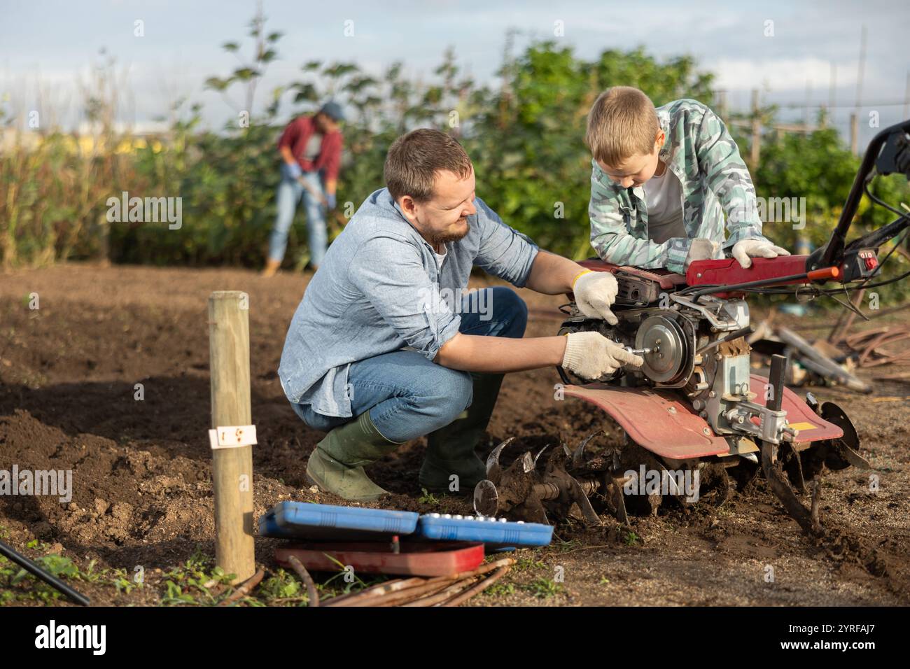 Man and his son are repairing garden equipment Stock Photo - Alamy