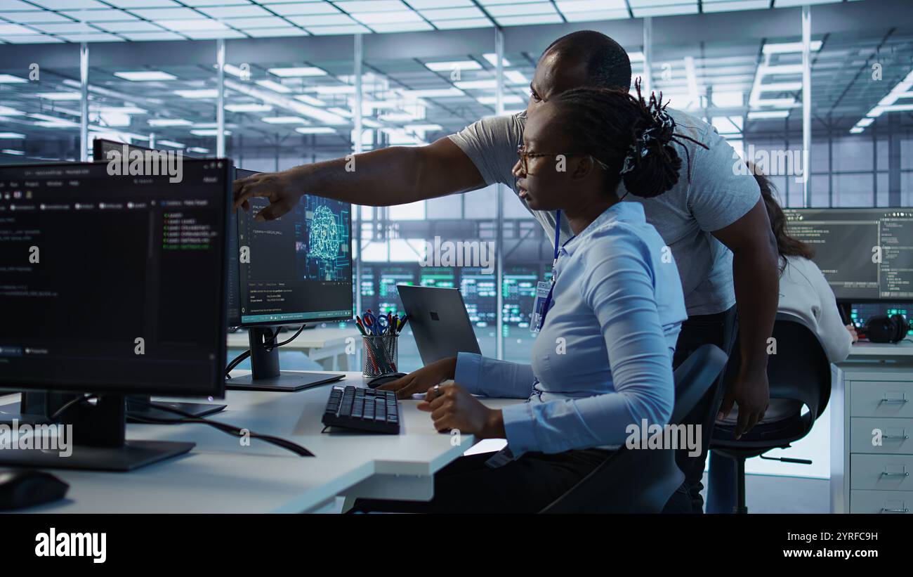 Manager coming to technician desk to give instructions on doing maintenance on artificial ...