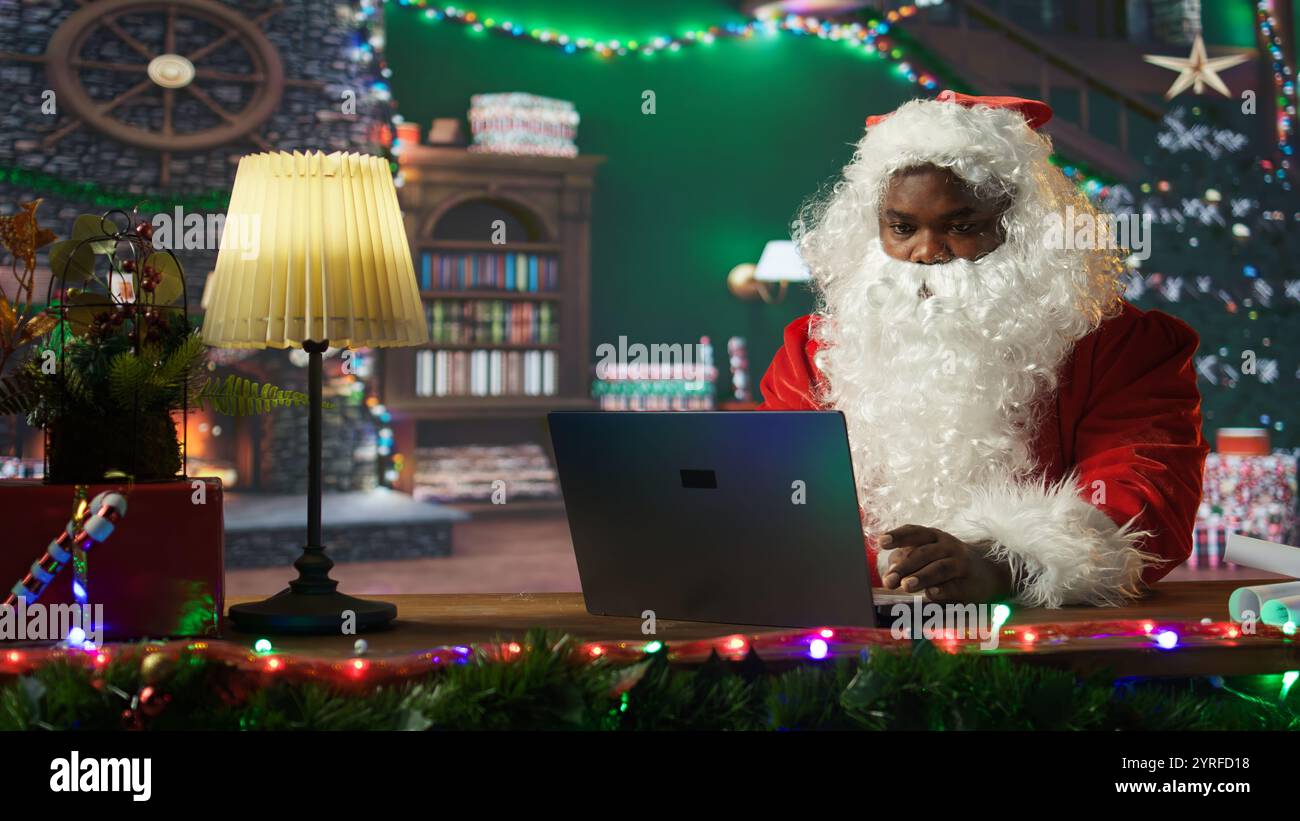 African american Father Christmas navigating web checking on children ...