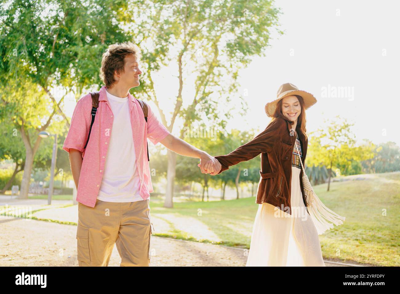 Young couple joyfully walking hand hi-res stock photography and images ...