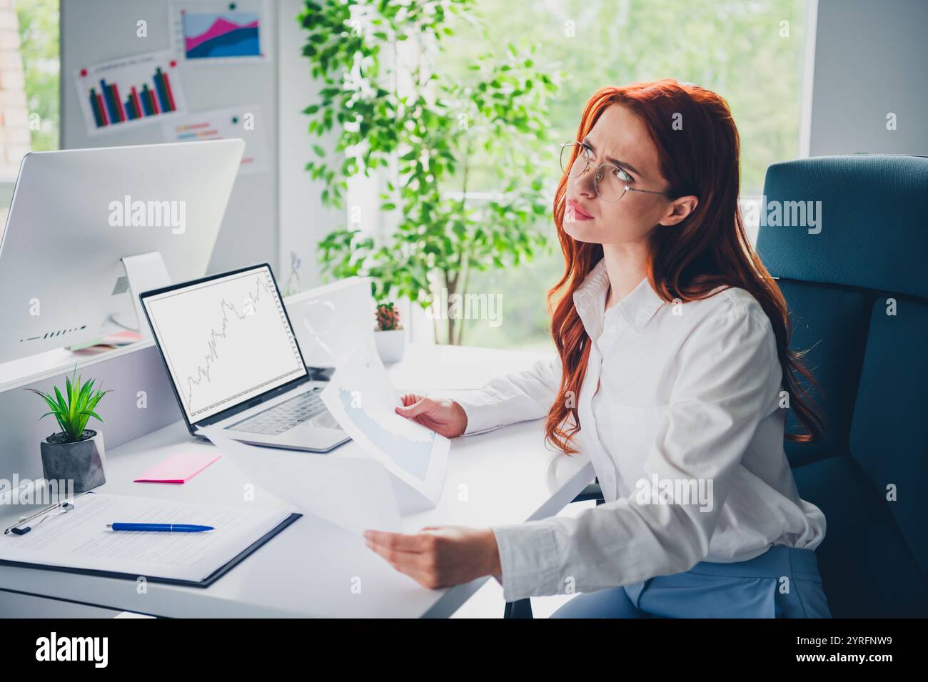 Photo of lovely young lady skeptical upset unsure work papers dressed ...