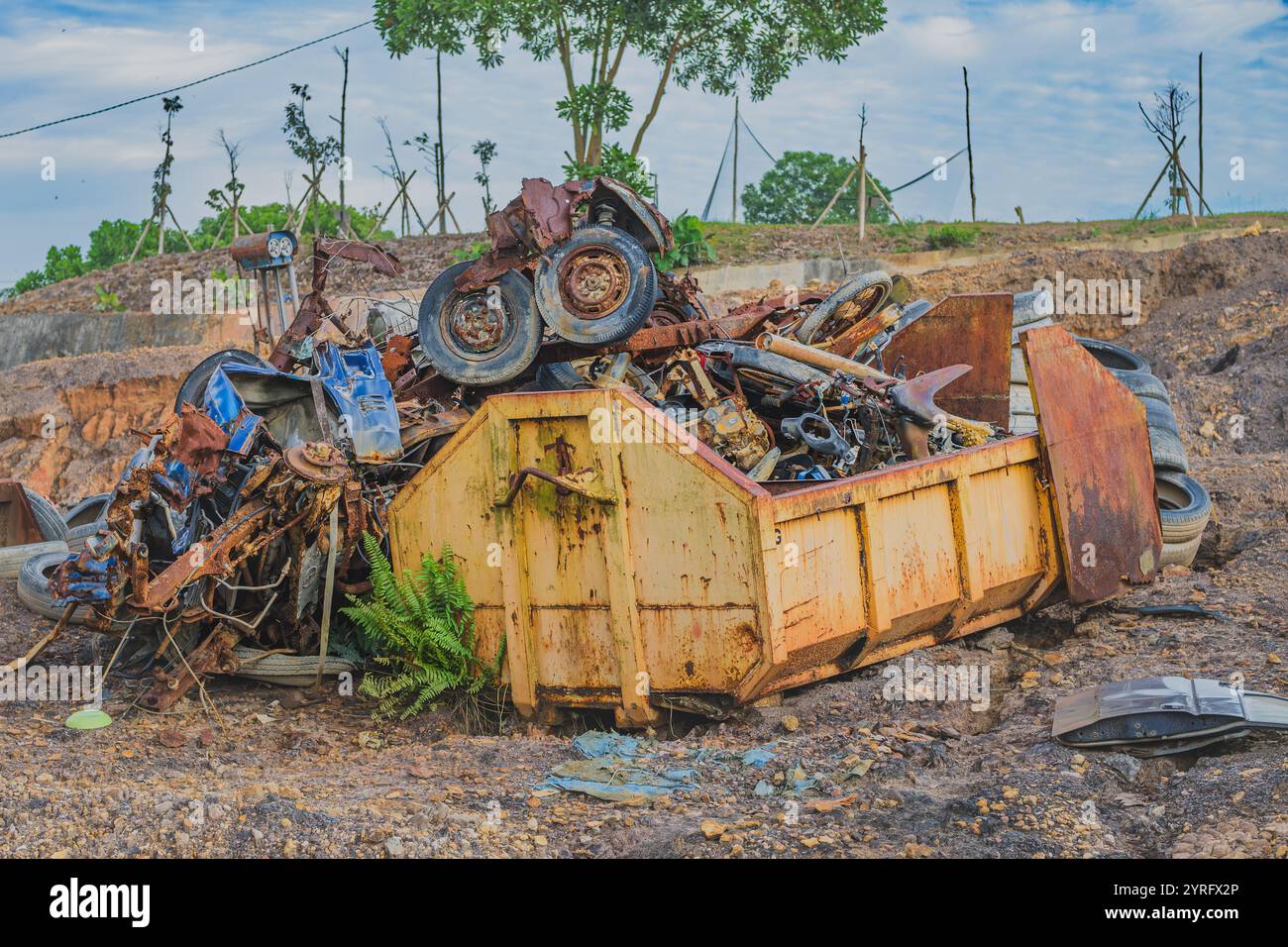 A rusty metal container filled with discarded machinery and scrap metal ...
