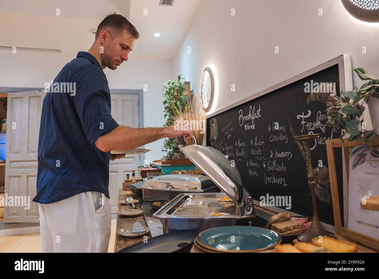 Man Serving at Breakfast Buffet in Marrakech Style Boutique Hotel Stock ...