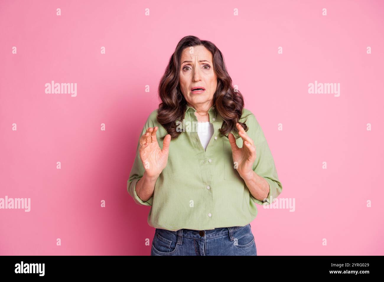 Photo of horrified mature age attractive woman raised hands up shocked ...