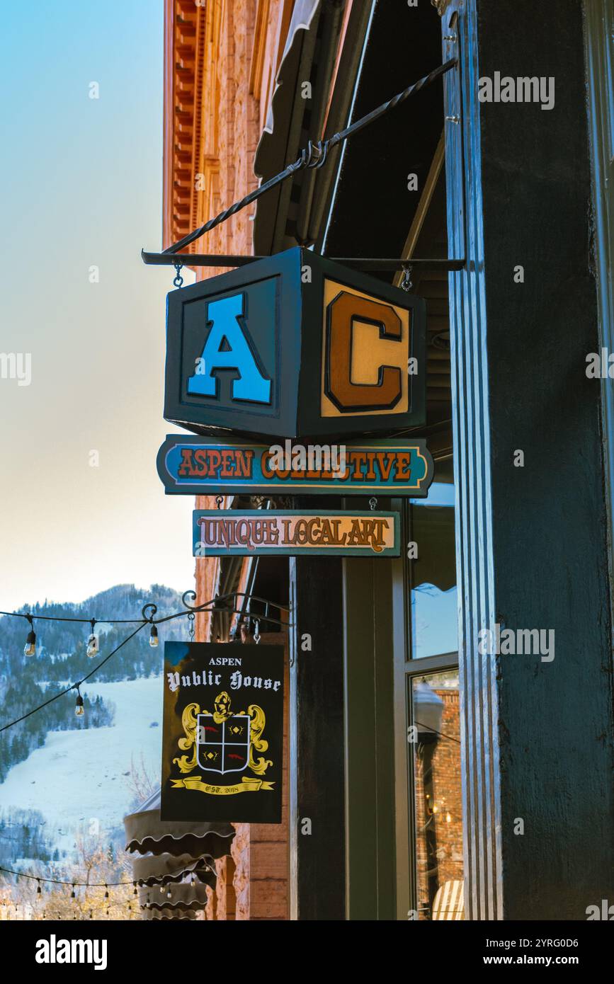 Storefront hanging shop signs for AC Aspen Collection and the Public ...