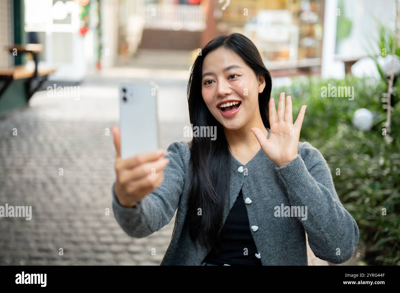 Woman waving goodbye on street hi-res stock photography and images - Alamy