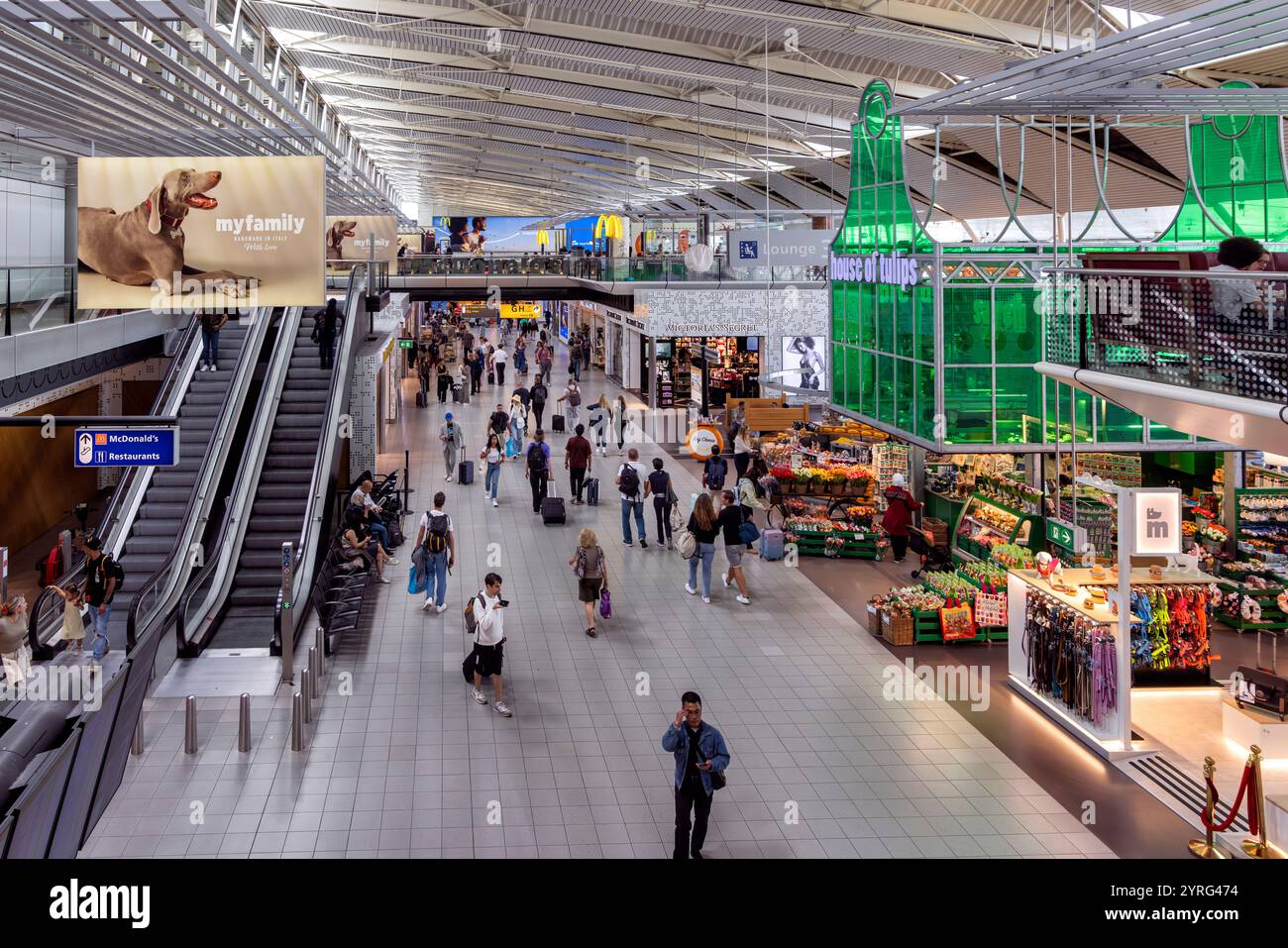 Passengers in terminal building at Schipol International Airport ...