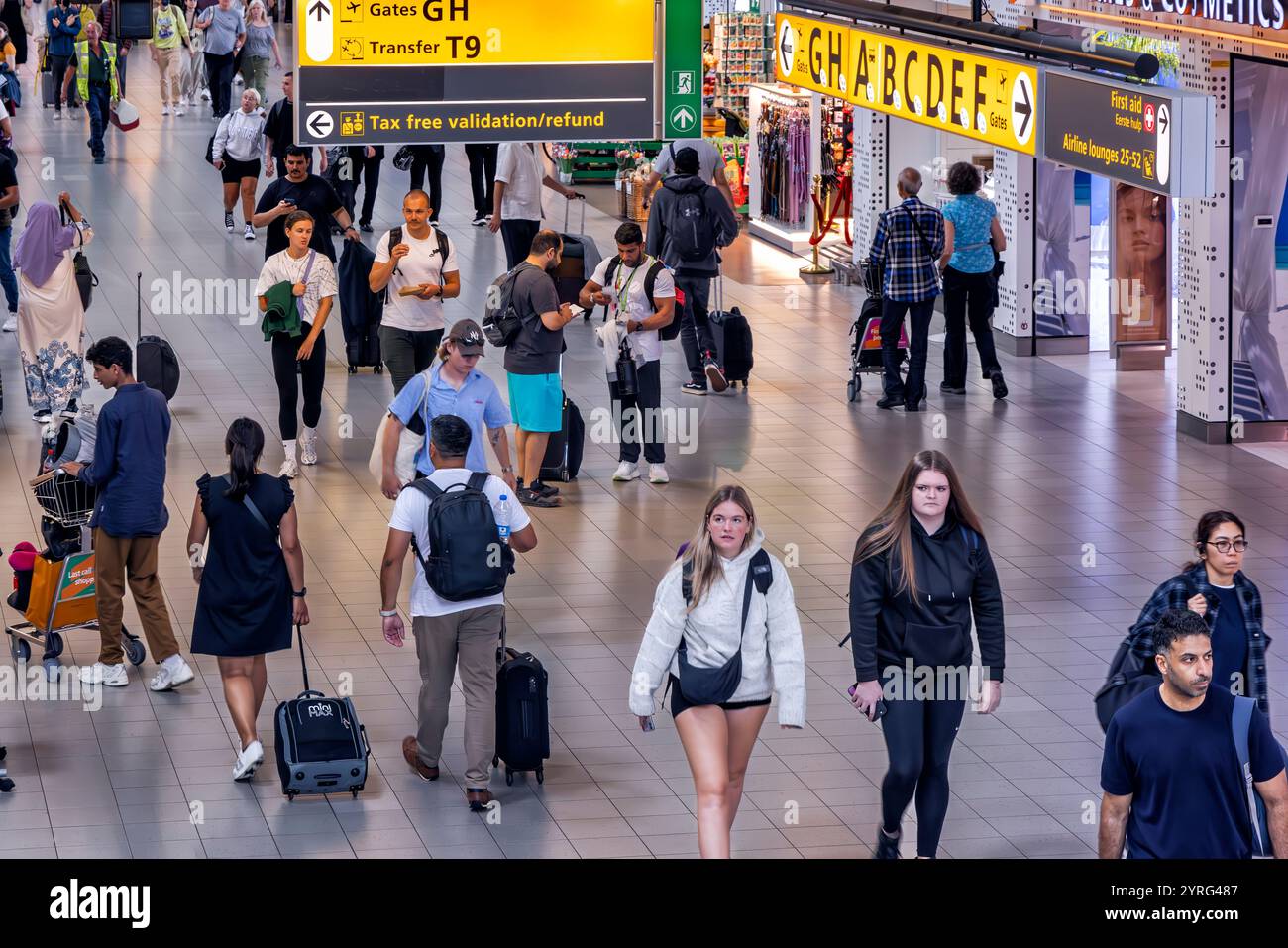 Passengers in terminal building at Schipol International Airport ...