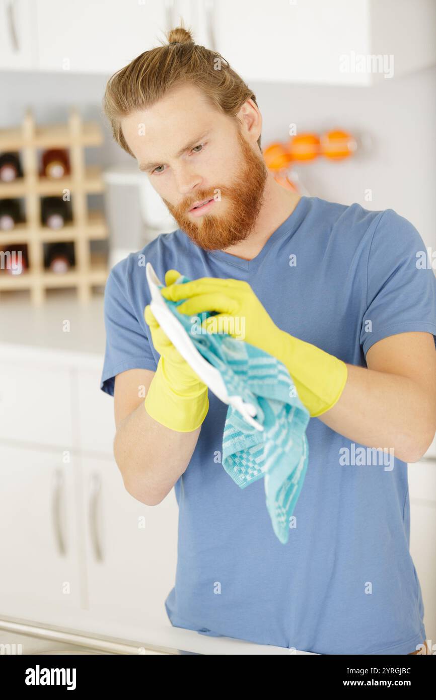 man washing dishes after dinner at kitchen Stock Photo - Alamy