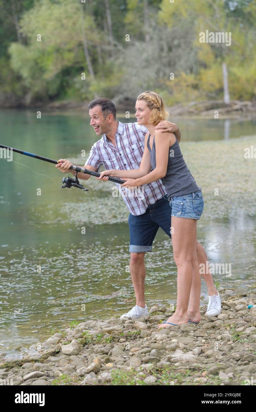 couple fishing caught a fish Stock Photo - Alamy