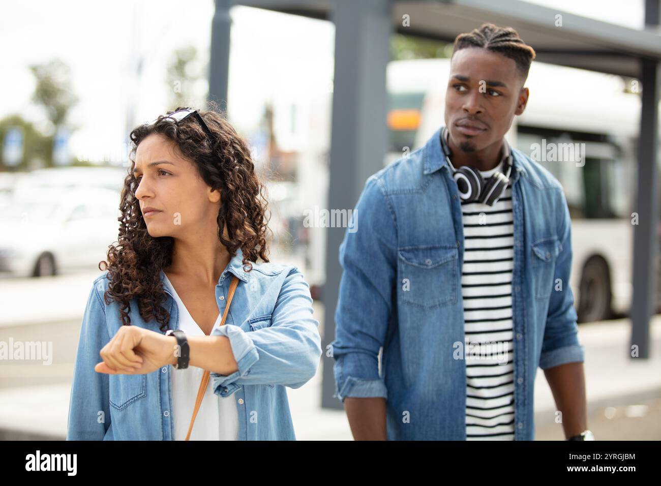 queue of people waiting at bus stop Stock Photo - Alamy