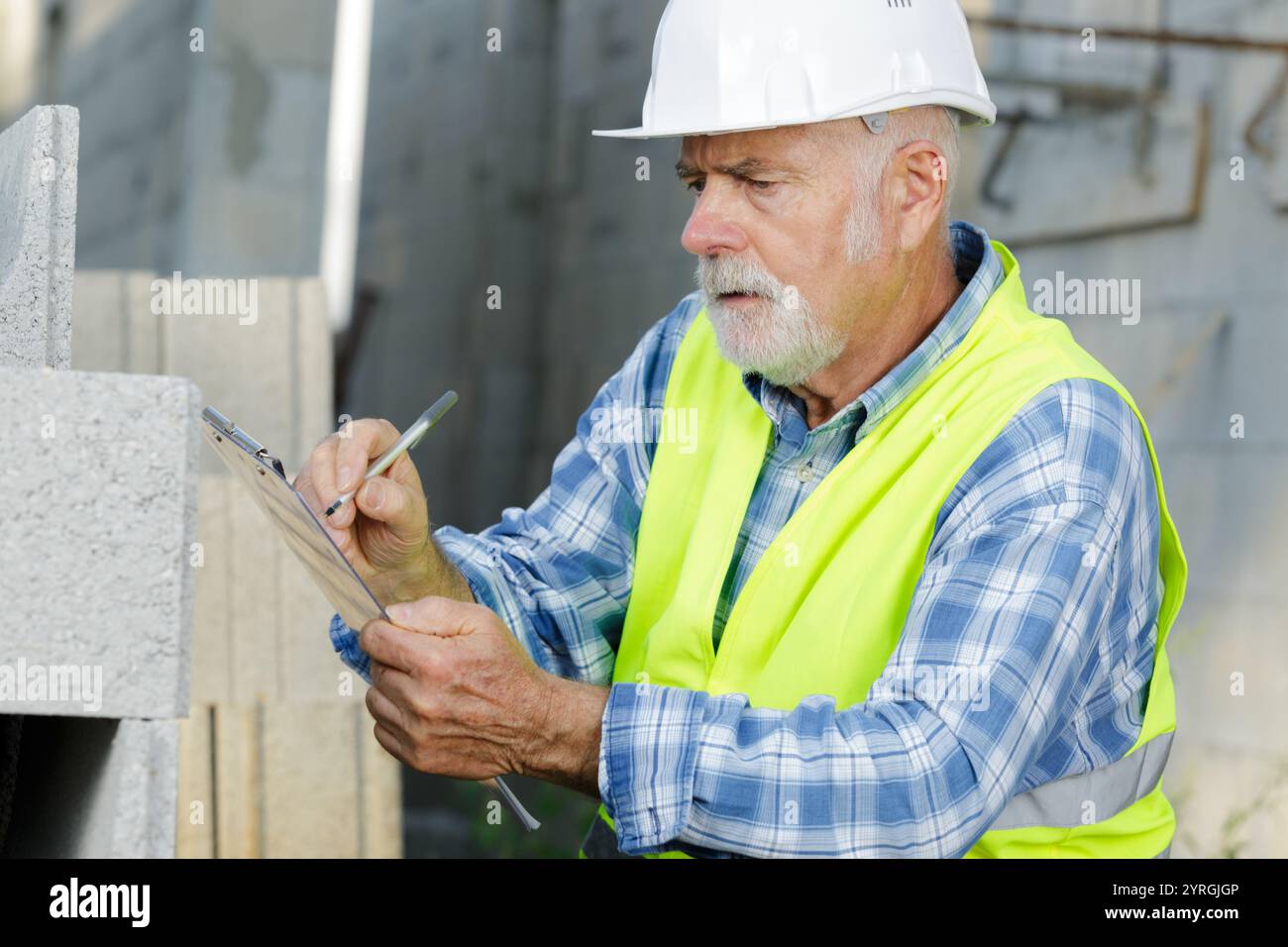male civil engineer wearing protective vest and hardhat Stock Photo - Alamy