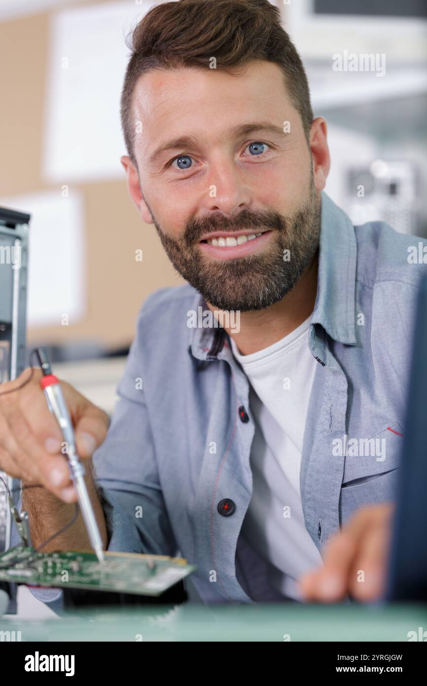 Smiling pc engineer repairing hi-res stock photography and images - Alamy