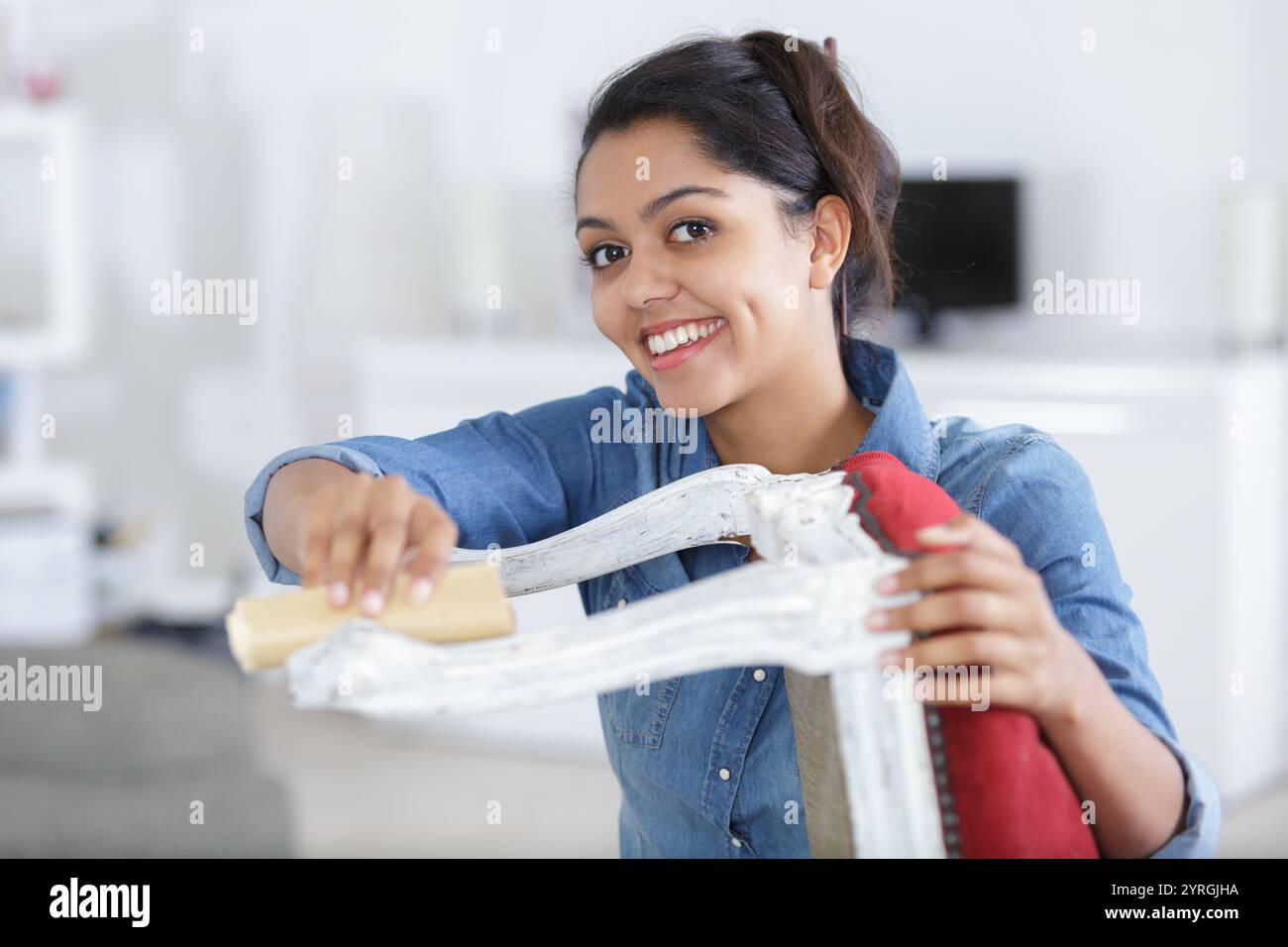 Happy woman sanding chair hi-res stock photography and images - Alamy