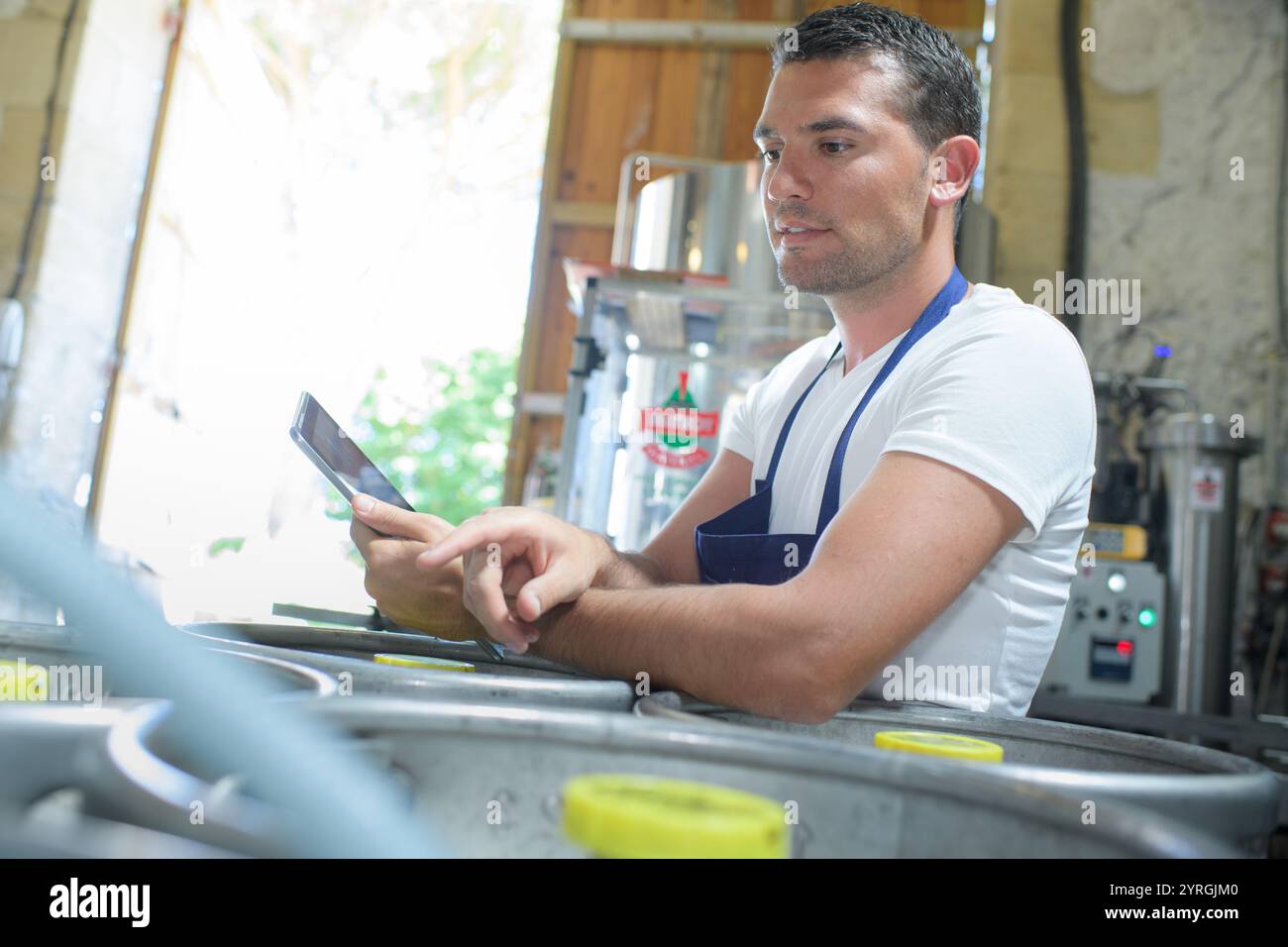 worker working with barrel at a brewery Stock Photo - Alamy