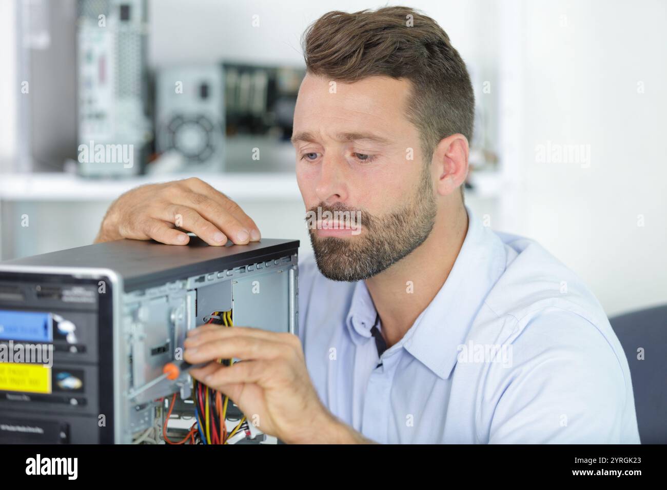 male worker fixing a pc Stock Photo - Alamy