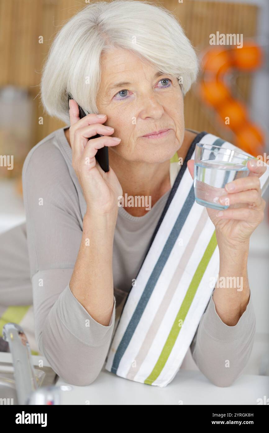 woman with phone drinking water Stock Photo - Alamy