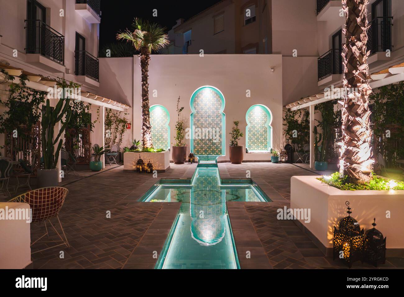 Luxurious Moroccan Courtyard at Night with Reflective Pool Stock Photo ...