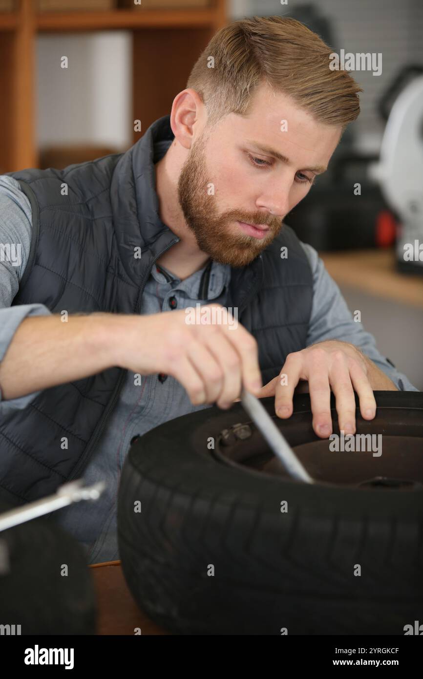 Mechanic working on tyre hi-res stock photography and images - Alamy