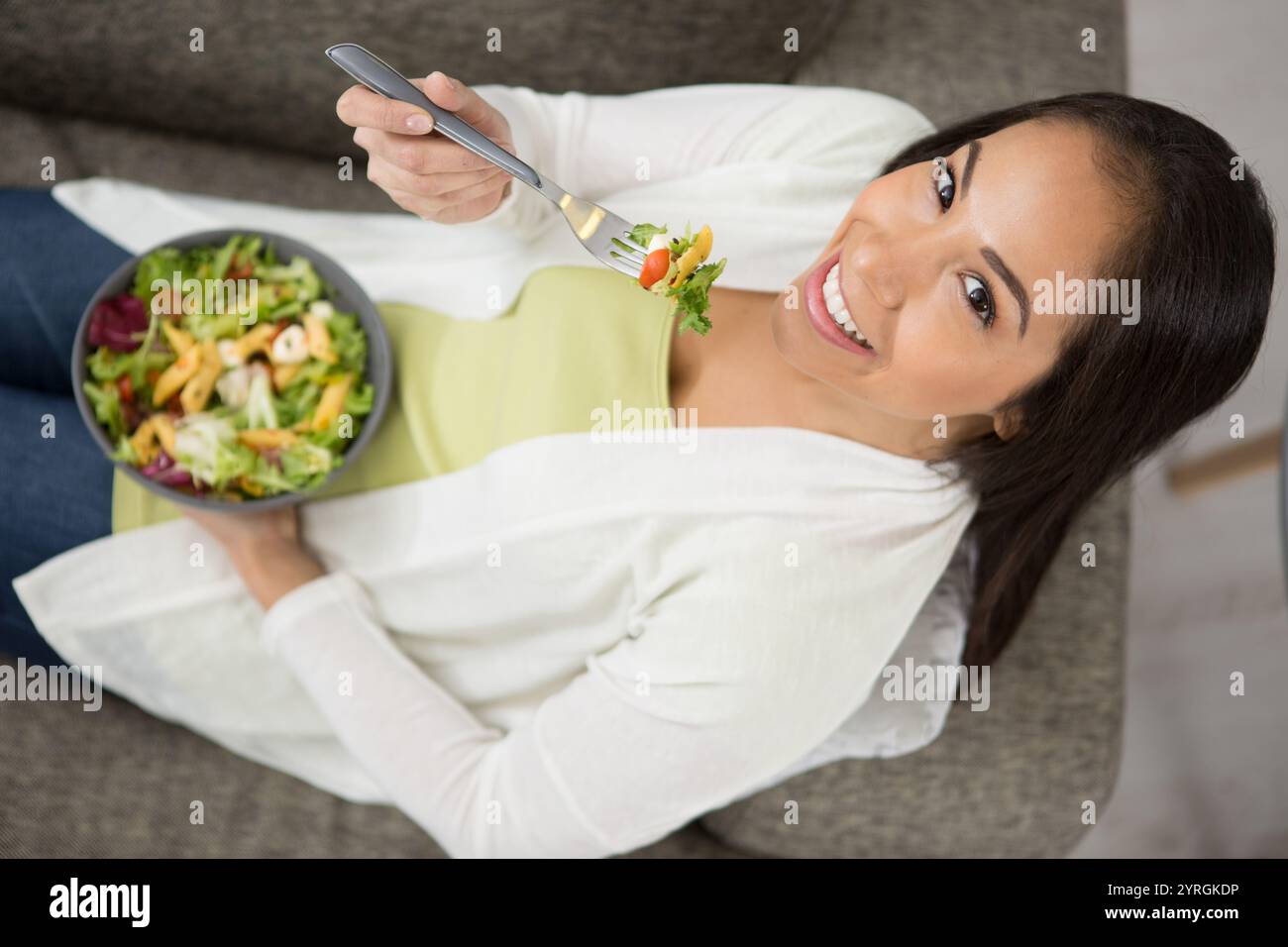 beautiful woman eating a pasta salad Stock Photo - Alamy