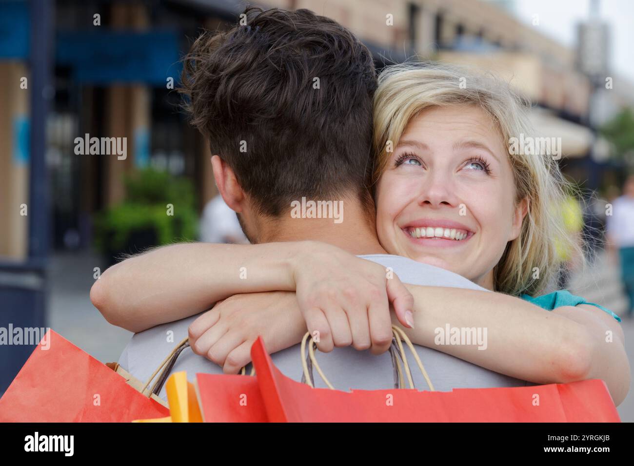 couple hugging in shopping mall Stock Photo - Alamy