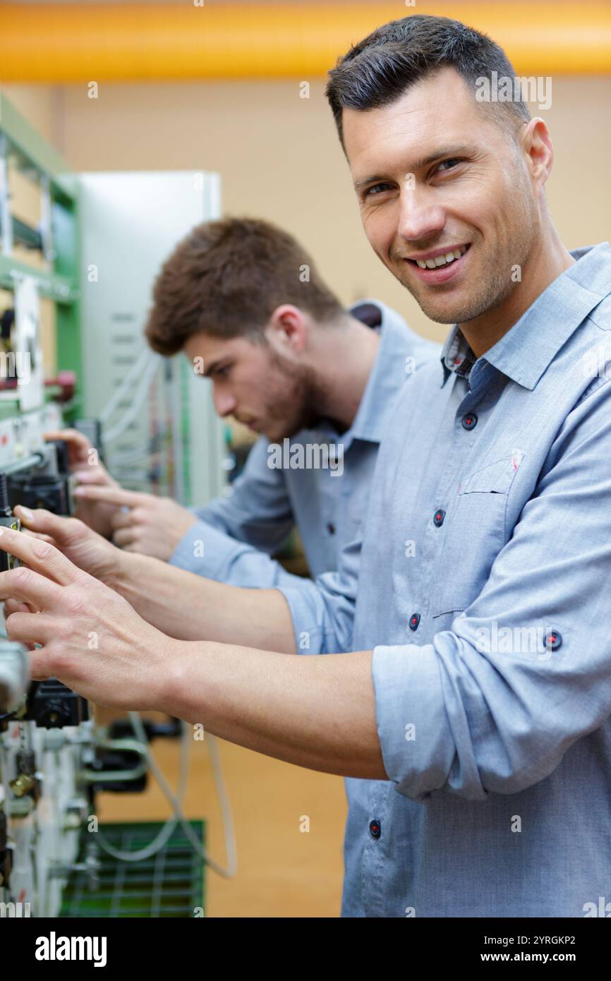 electrical engineer posing and smiling Stock Photo - Alamy