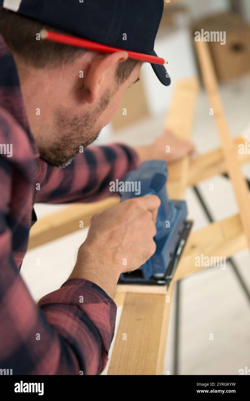 rear view of a carpenter using a sander Stock Photo - Alamy