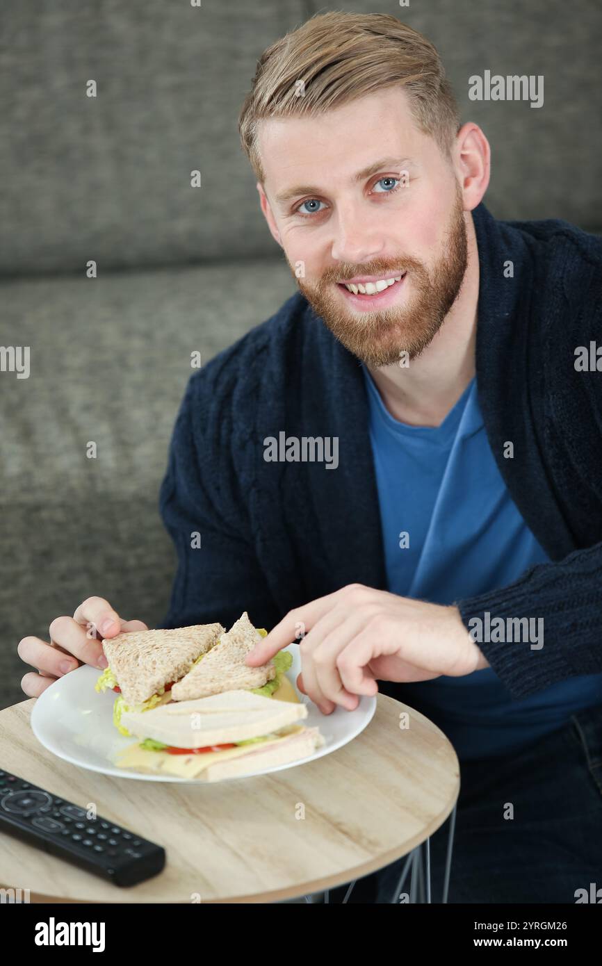 Young man eating lettuce leaf hi-res stock photography and images - Alamy