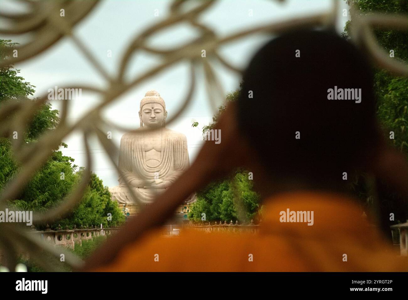 A monk paying attention to a 64-feet-high Great Buddha statue from ...