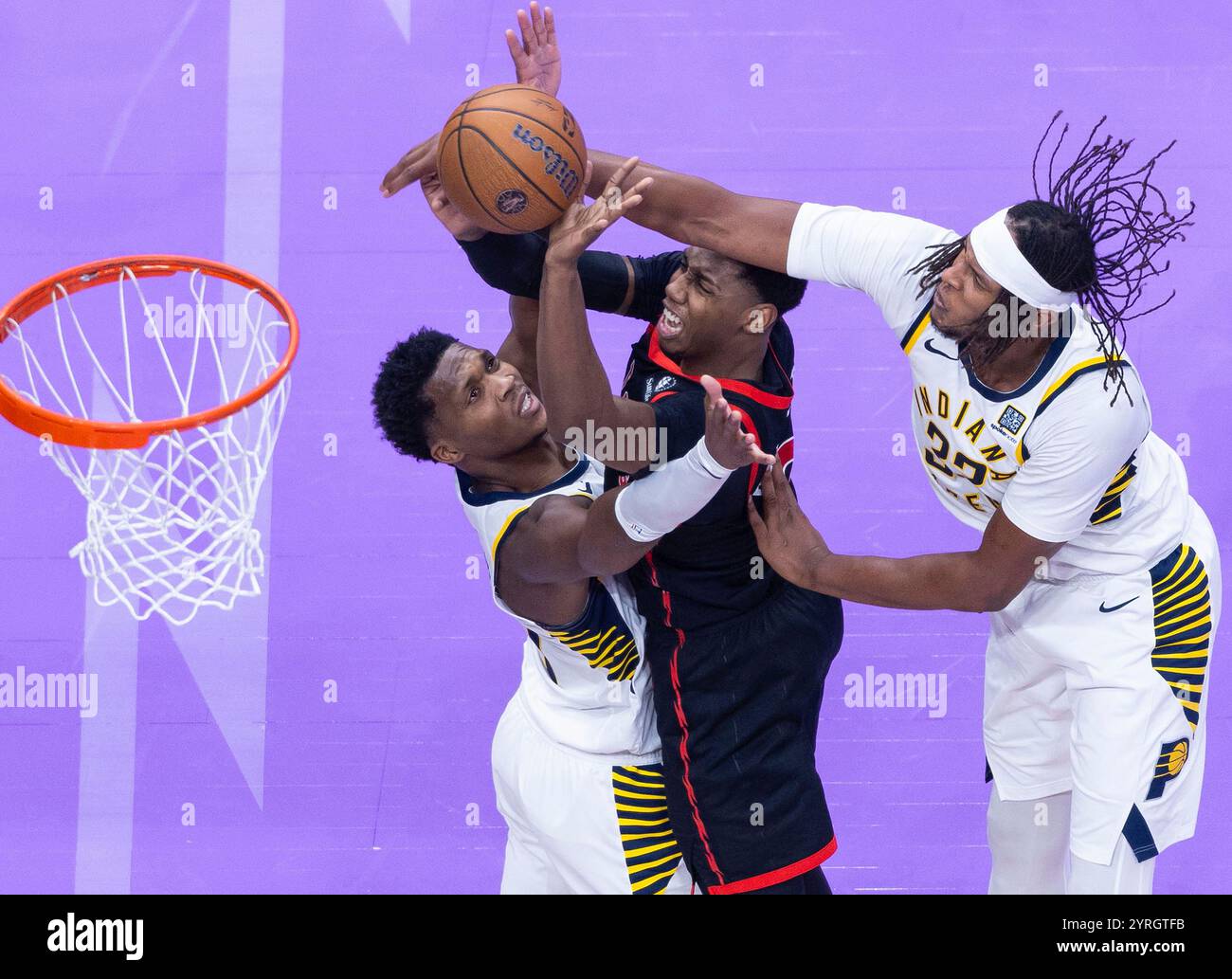 Toronto, Canada. 3rd Dec, 2024. RJ Barrett (C) of Toronto Raptors makes a layup as Myles Turner ...