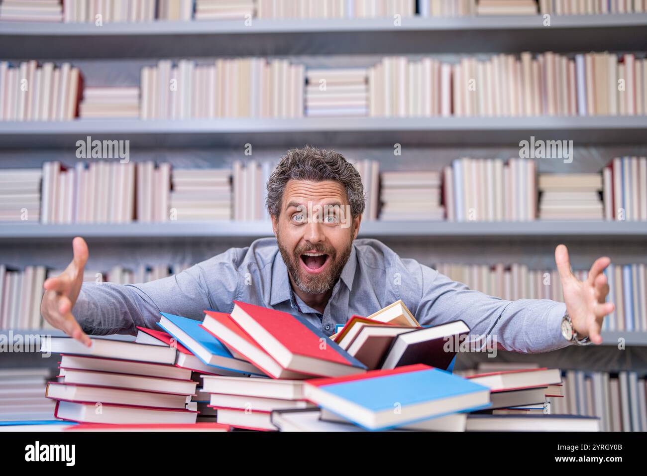 millennial college teacher in classroom. school classroom full of books ...