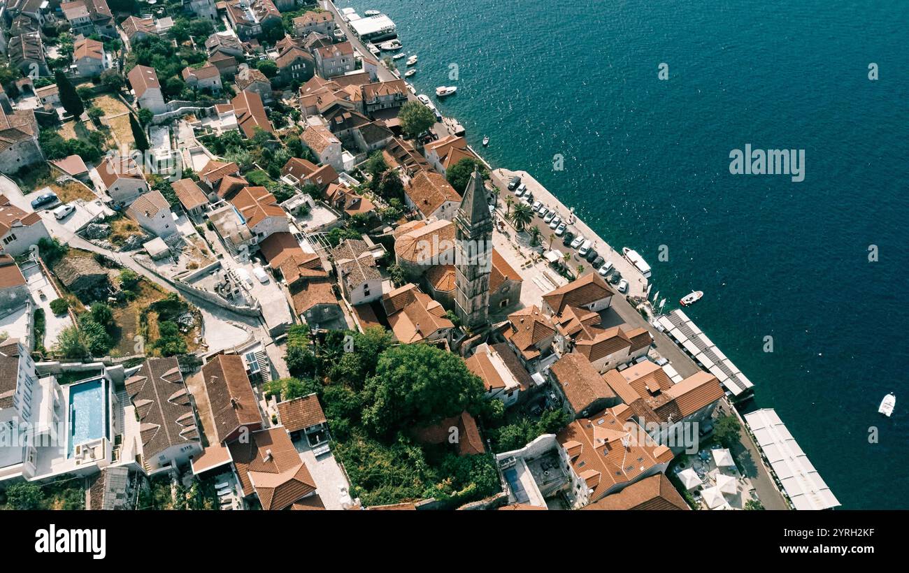 Bell tower of the Church of St. Nicholas among the red roofs of houses ...
