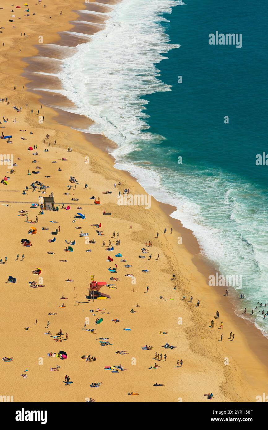 Aerial view of the beach of nazare in portugal, full of tourists ...