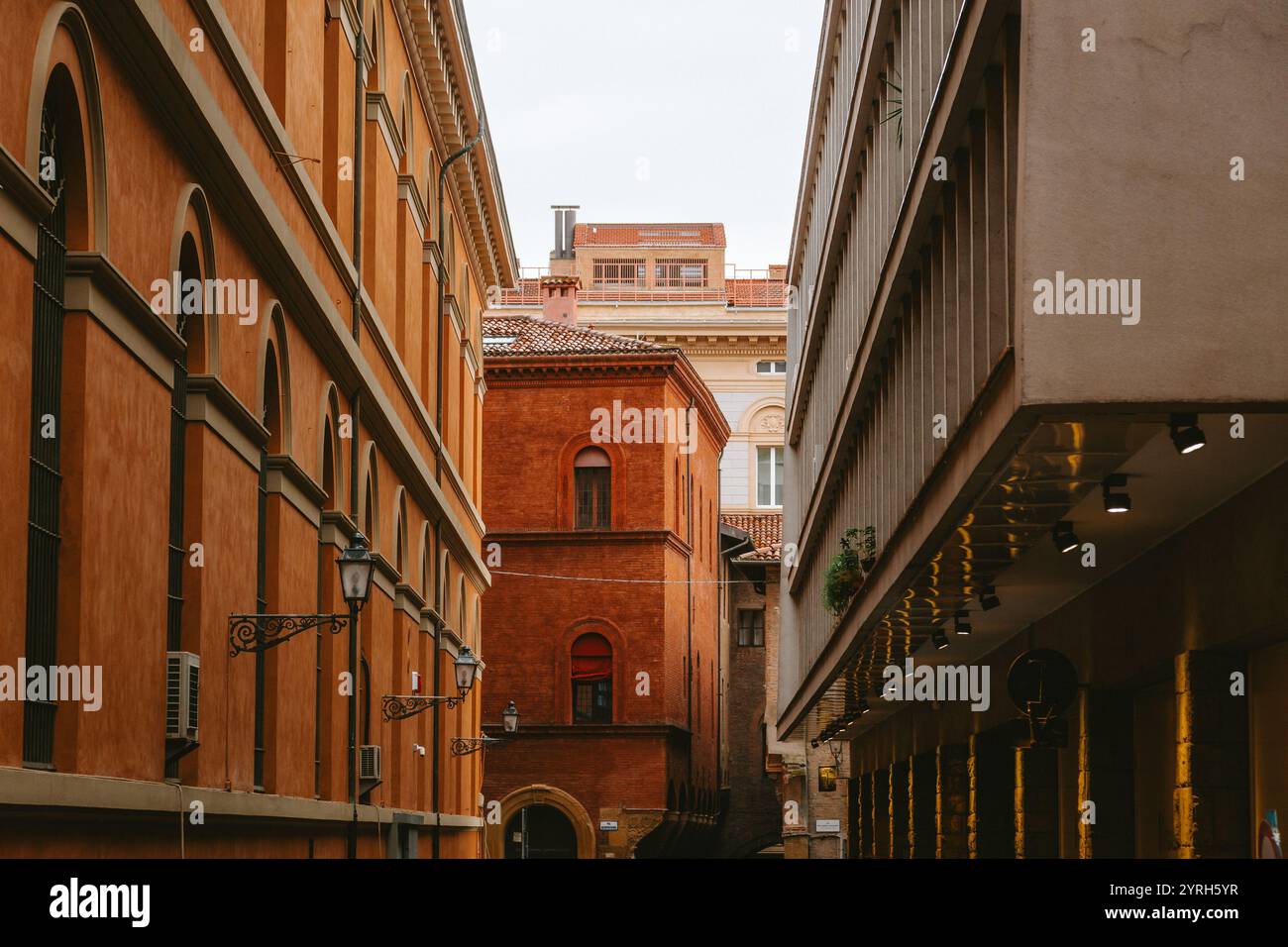 Bologna cityscape featuring narrow street with traditional buildings ...