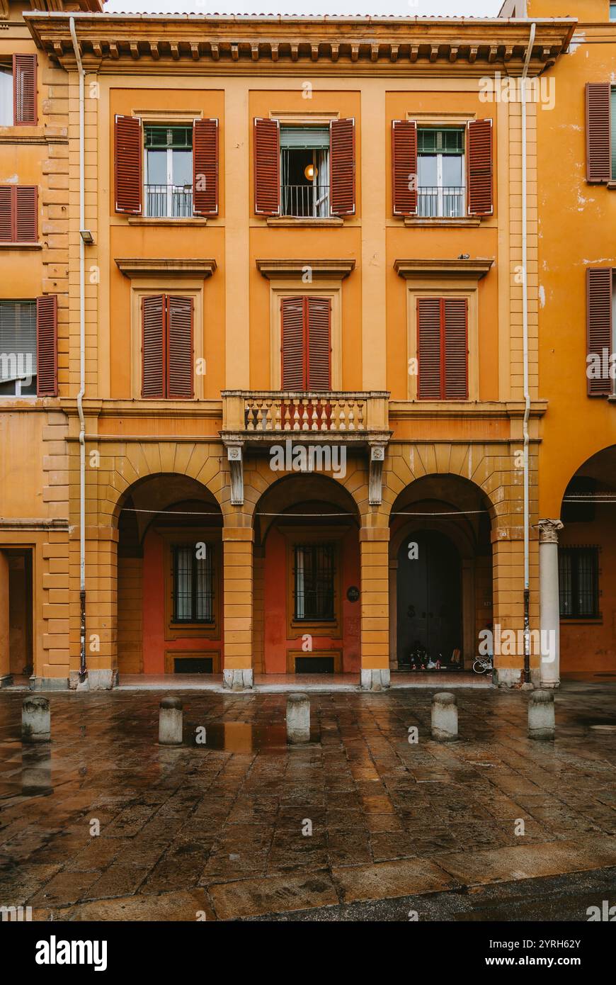 Eye level view of orange building in bologna with arched entrances ...