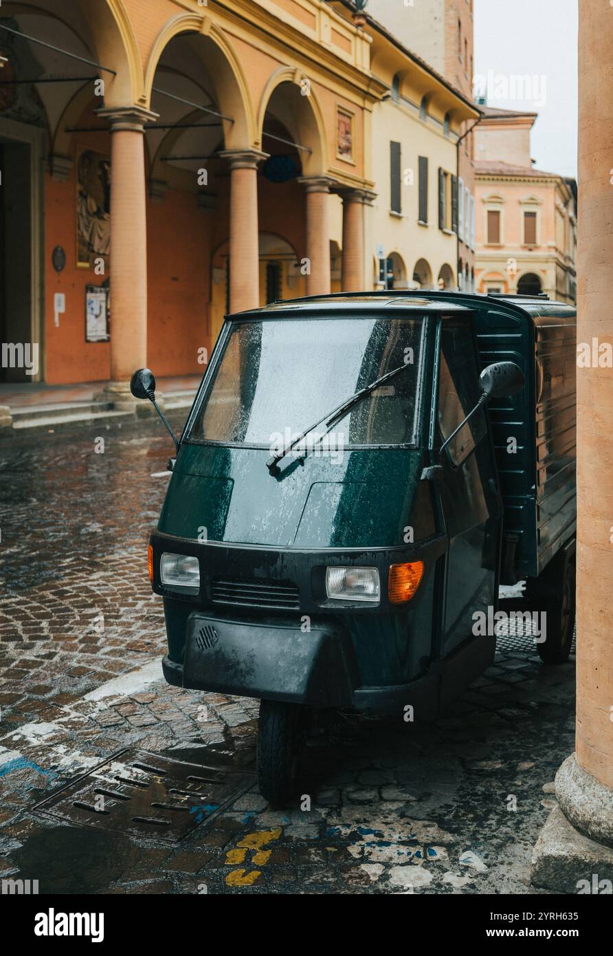 Charming three wheeled van, parked on a cobblestone street in bologna ...