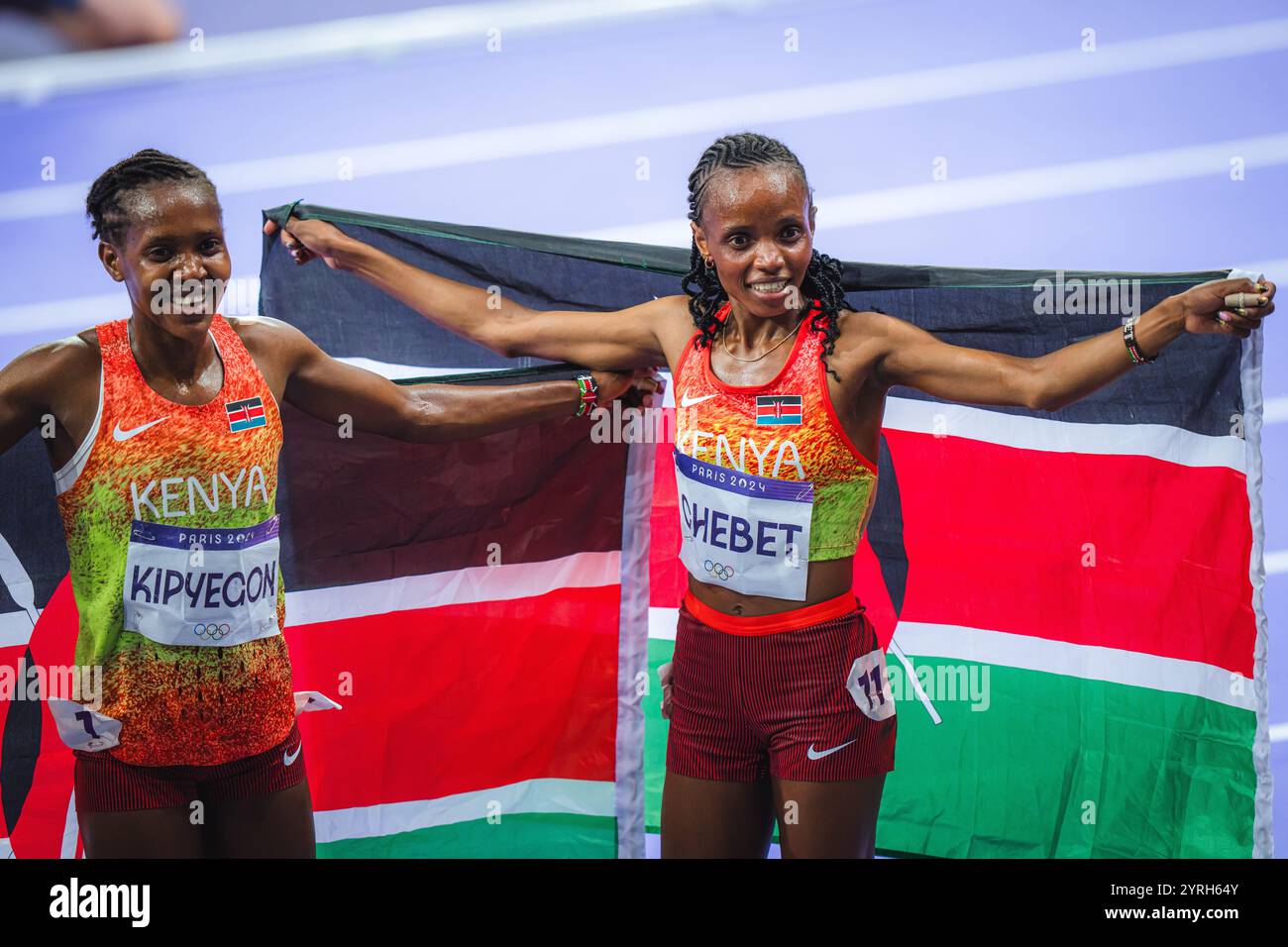 Beatrice Chebet celebrating her medal with her country's flag at the ...