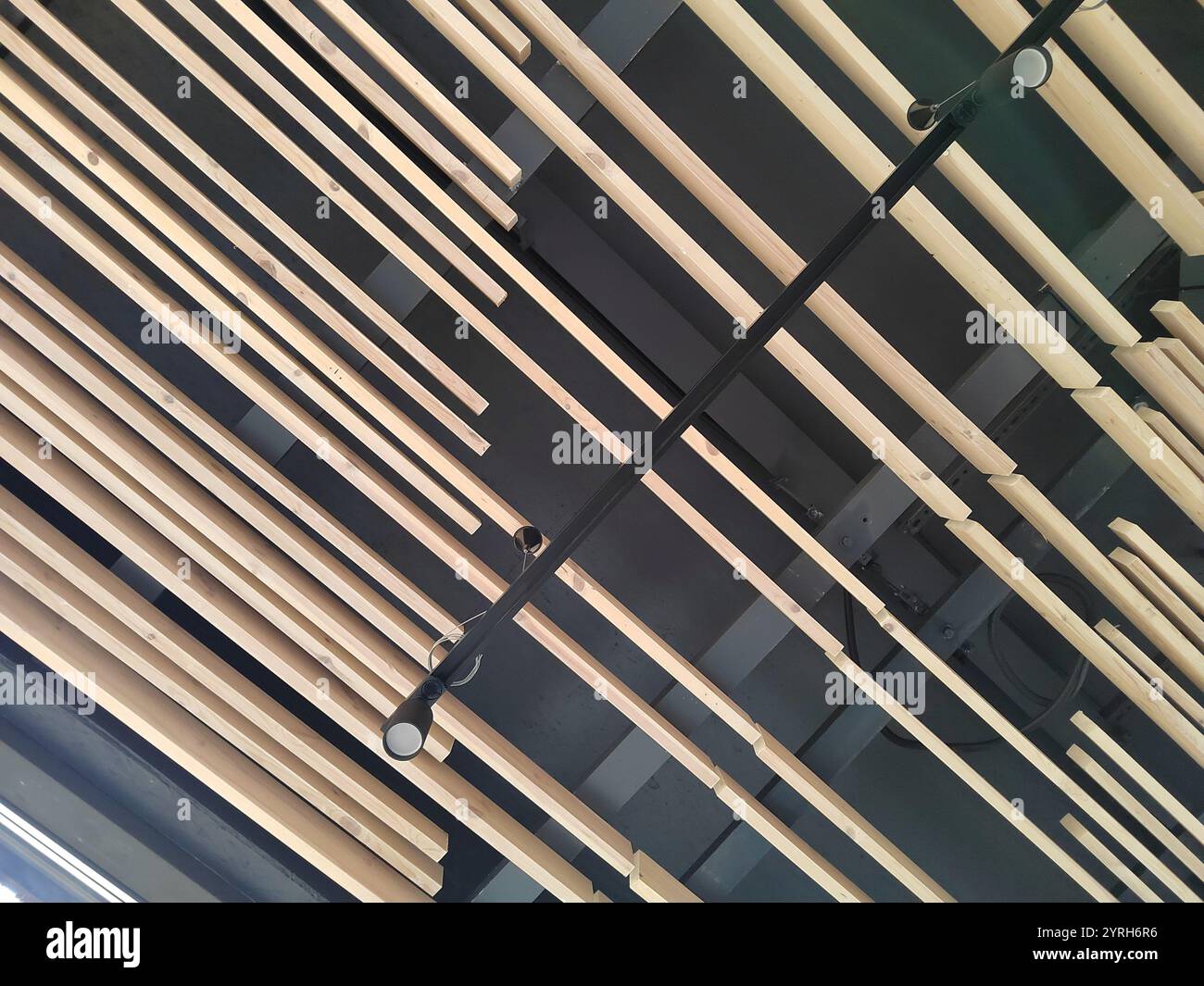 A detailed view of ceiling decor featuring natural wooden beams and ...