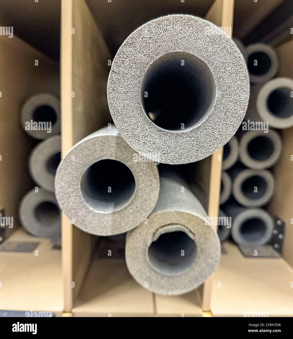 Stacked foam insulation pipes in various diameters and textures. High ...