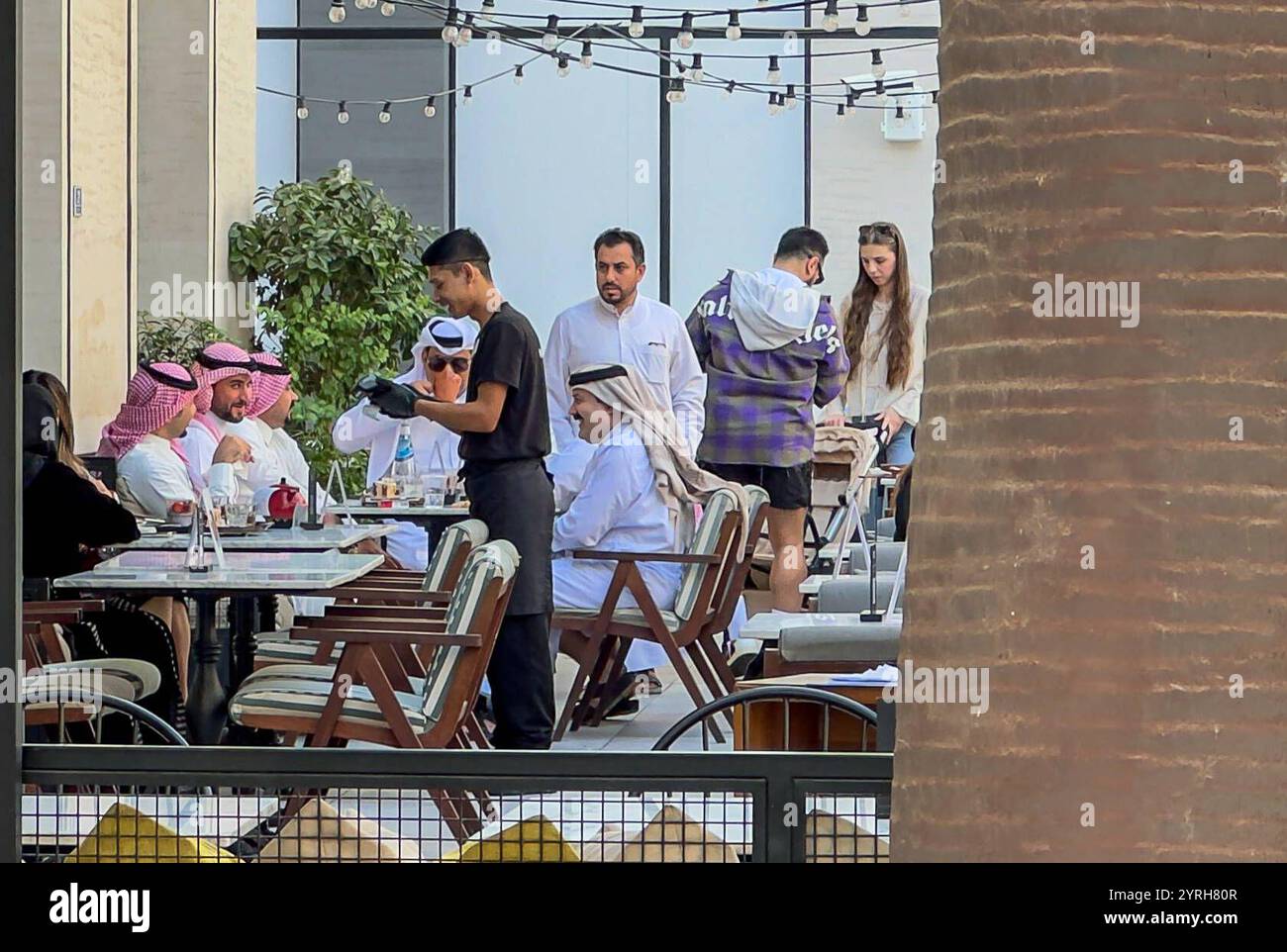 WINTER WEATHER IN DOHA, People sit outside a cafe in Downtown in the ...
