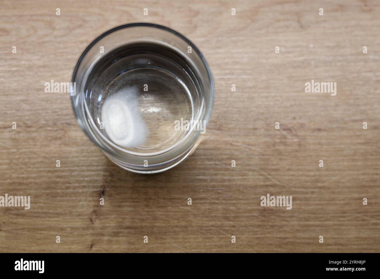Top view of glass with effervescent soluble tablet bubbling on the ...