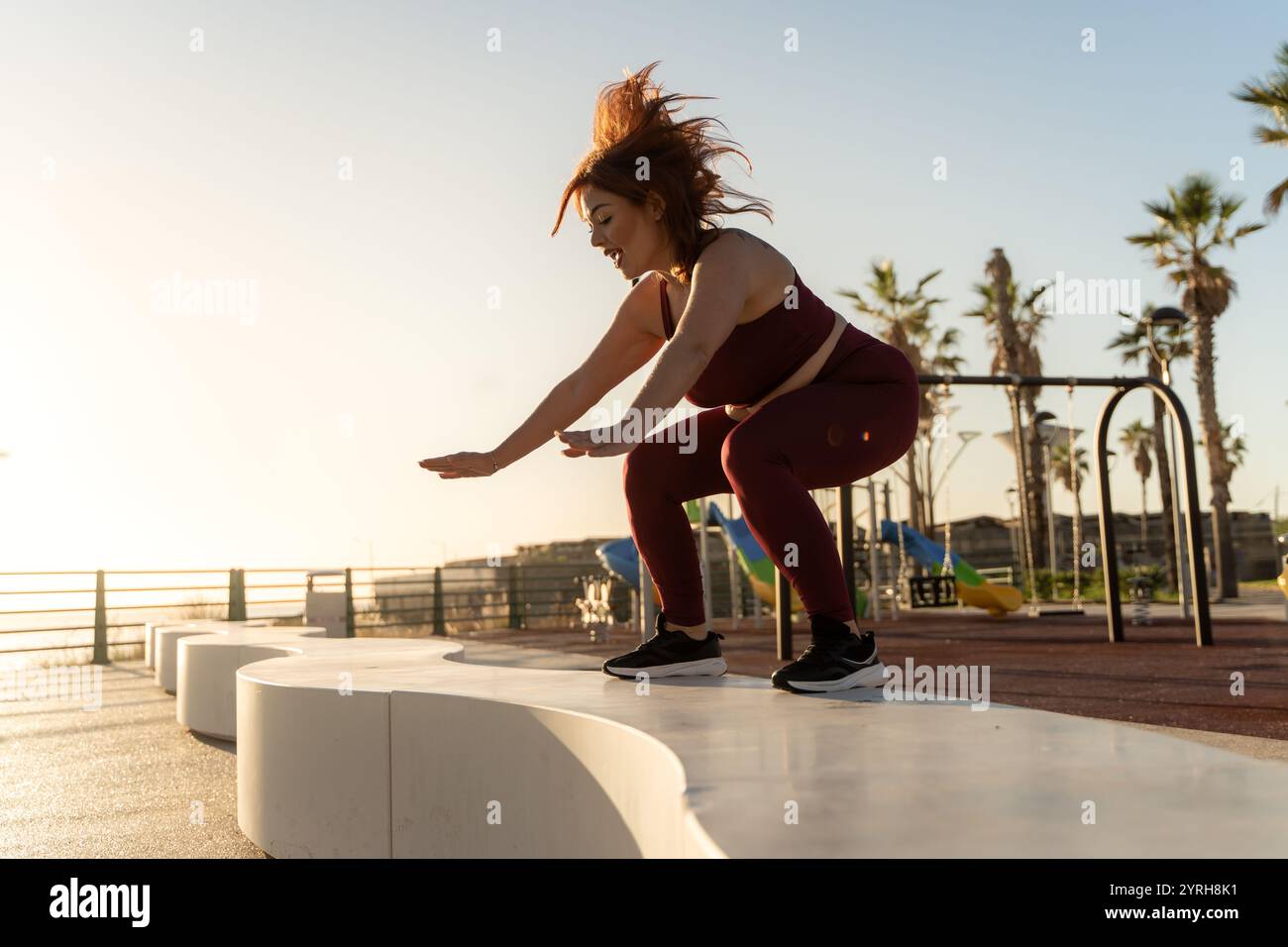 Plus size athlete doing functional training exercises at tropical ...